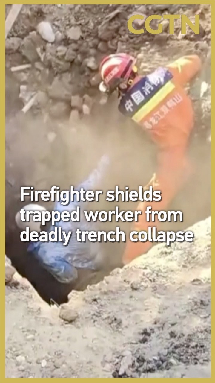 Firefighter shields trapped worker from deadly trench collapse