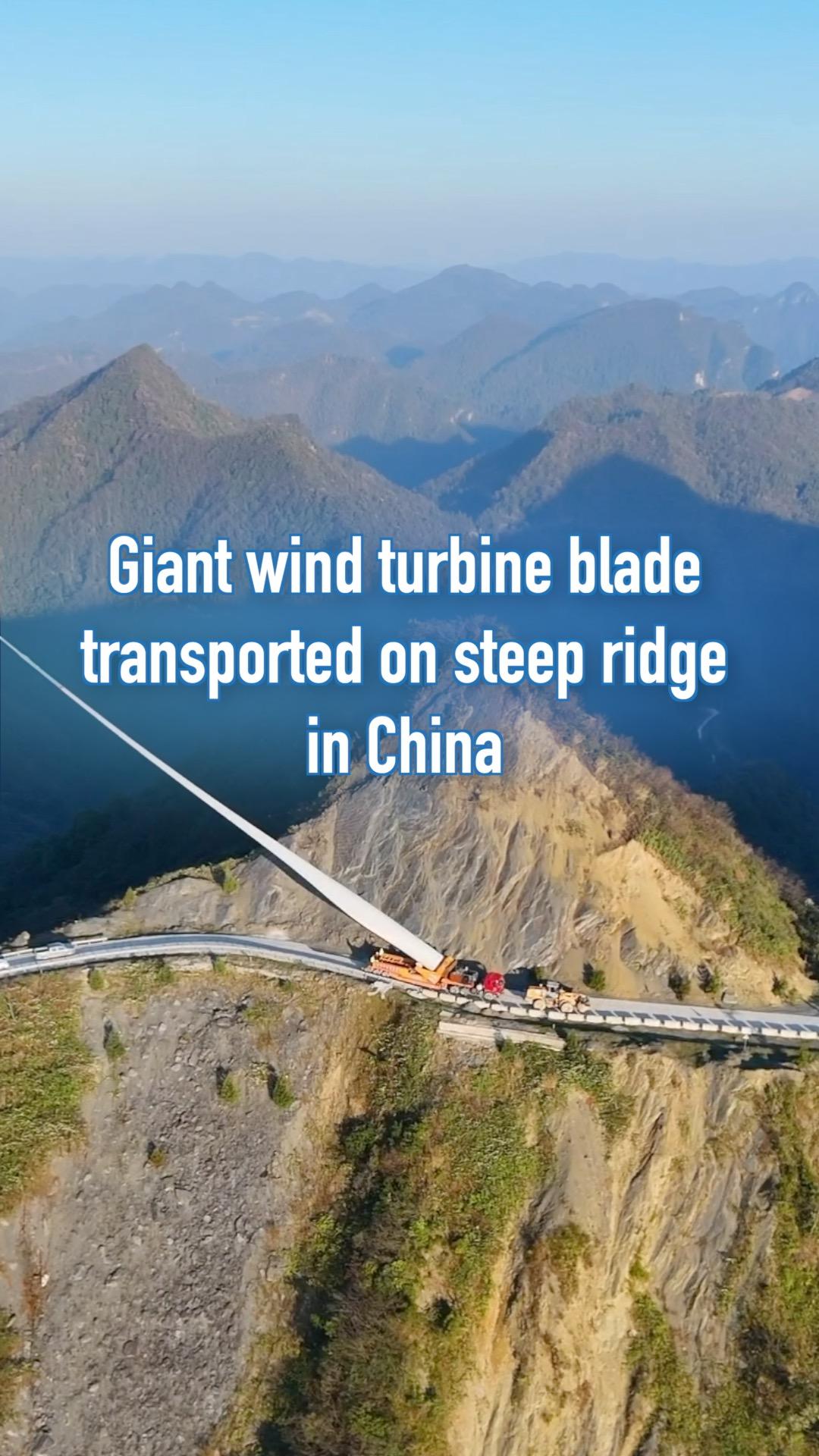 Giant wind turbine blade transported on steep ridge in China